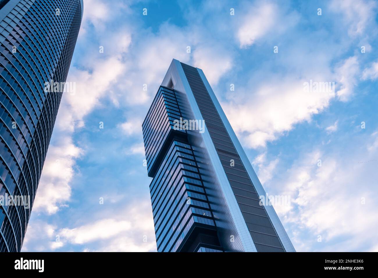 Financial area with glass buildings seen from below at sunrise, modern ...