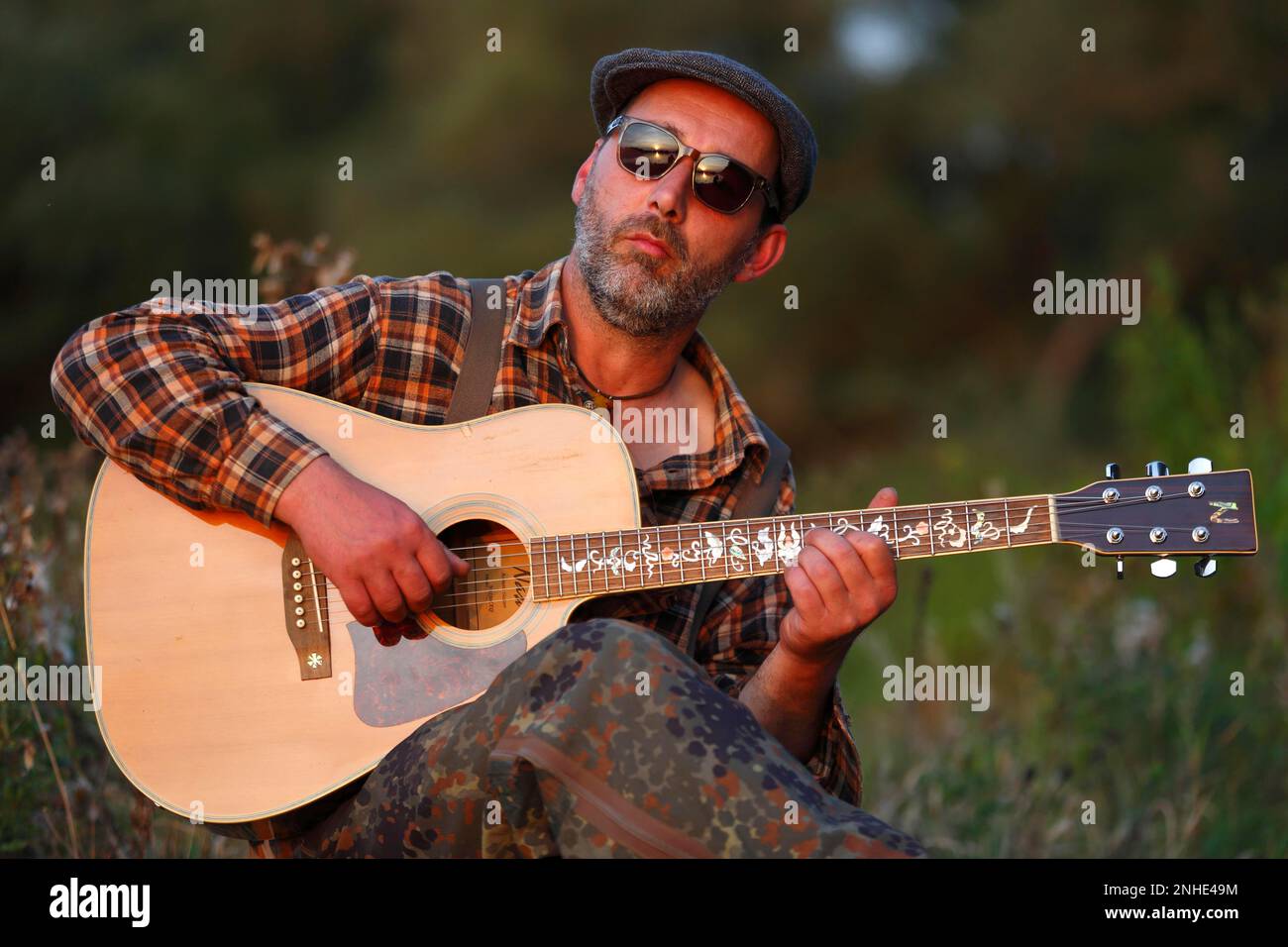 A man playing the guitar in nature, Middle Elbe Biosphere Reserve ...
