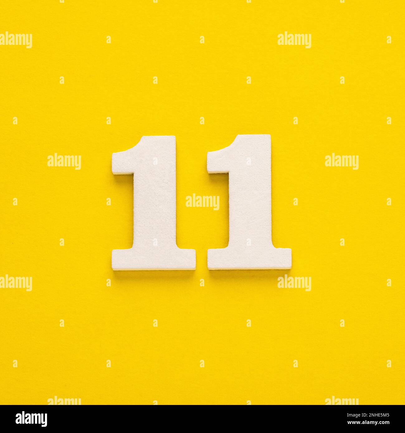 Number 11 - Two figures in white on a yellow background Stock Photo - Alamy
