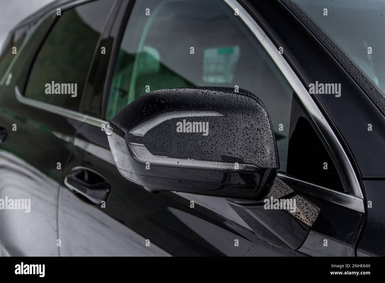 Side rear-view mirror on a modern car. Closeup photo of a car mirror ...