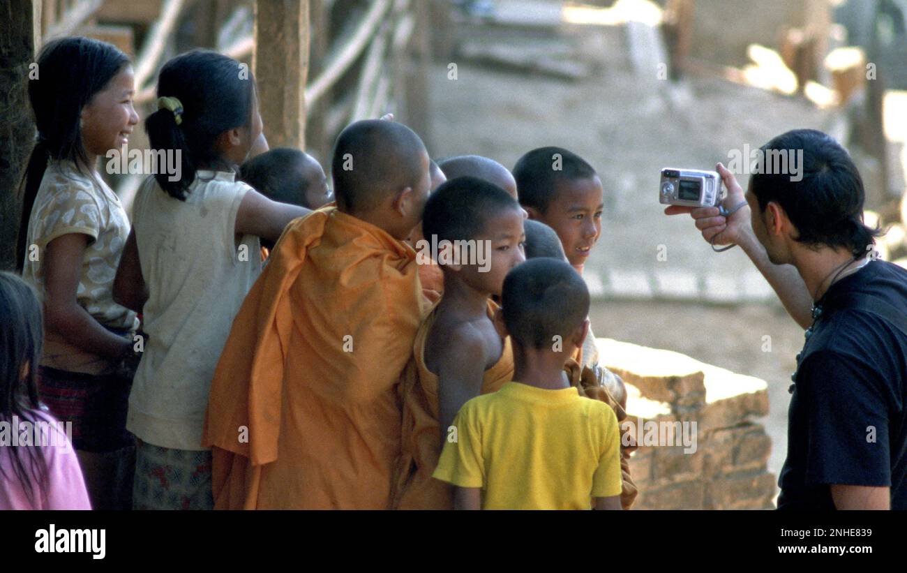 A tourist visits a small, indigenous Wa village in Myanmar (Burma) and ...