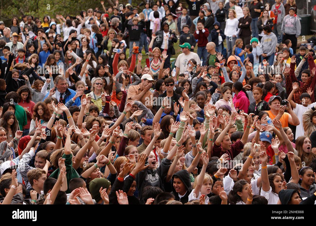 Kids raise their hands to the music of MC Hammer at the start of the ...