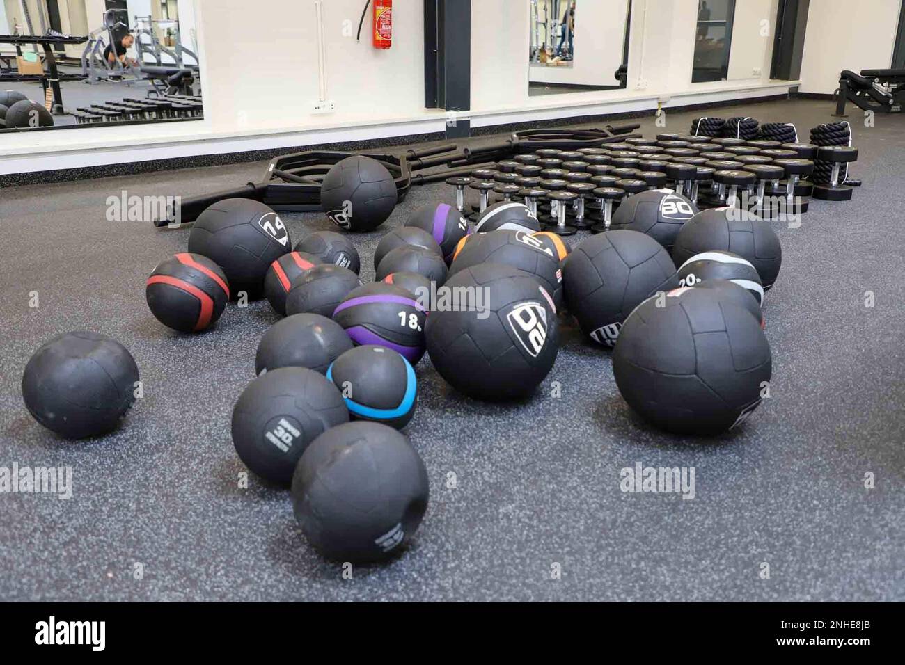 Medicine balls and dumbbells are unpacked and awaiting placement in the ...