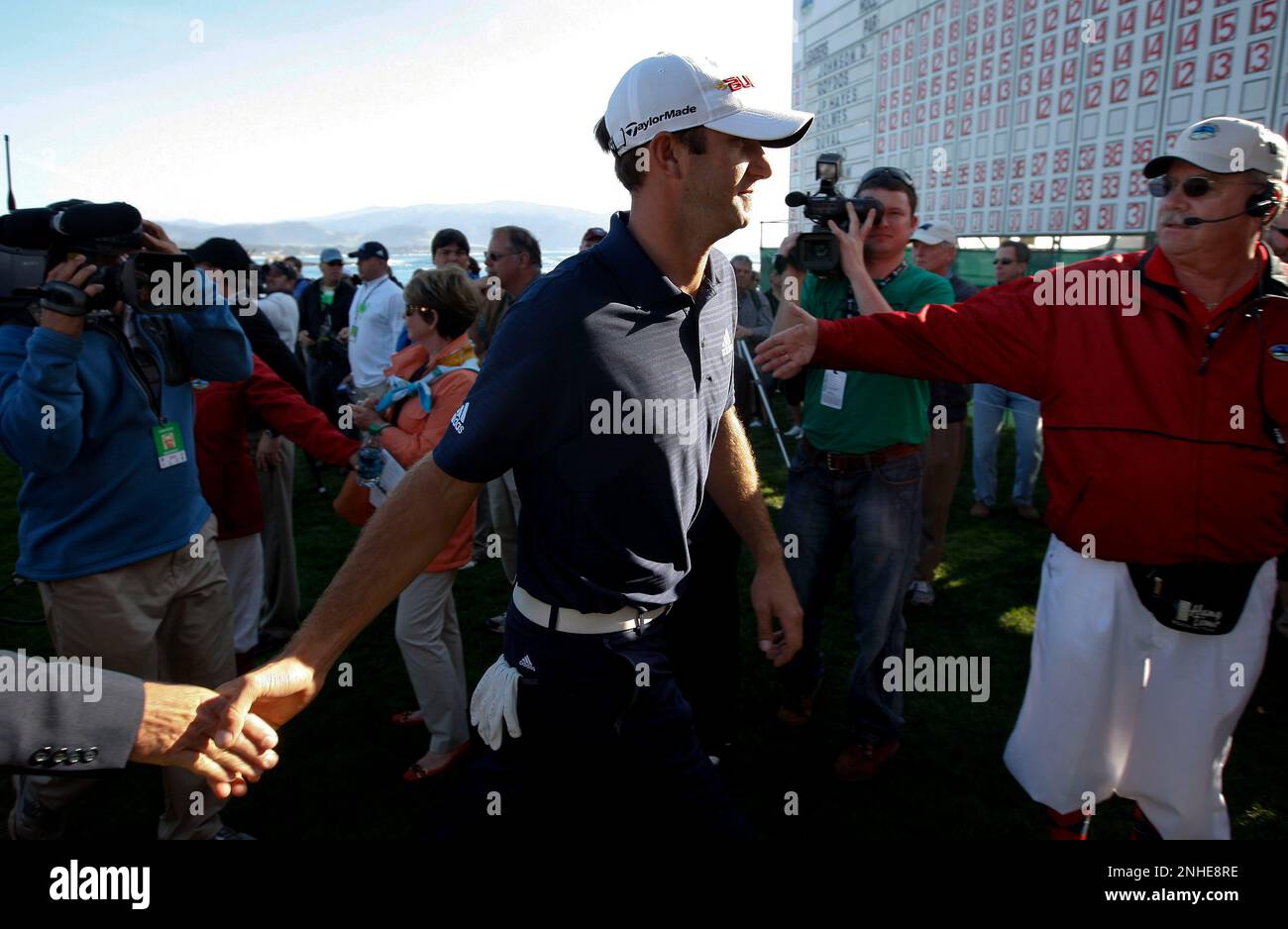 Dustin Johnson heads to the scoring tent following his victory at the ...