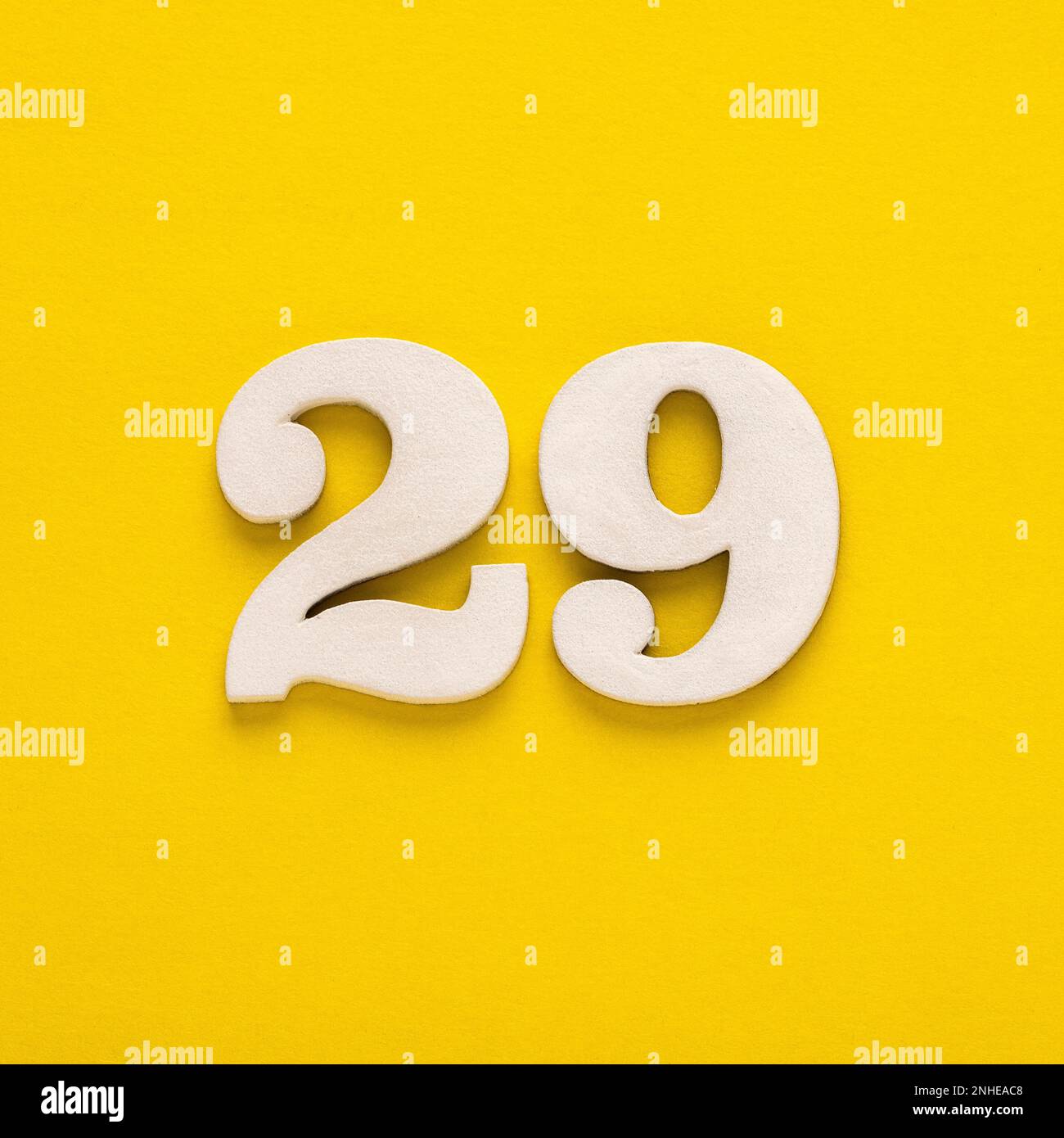Number 29 - Two figures in white on a yellow background Stock Photo - Alamy