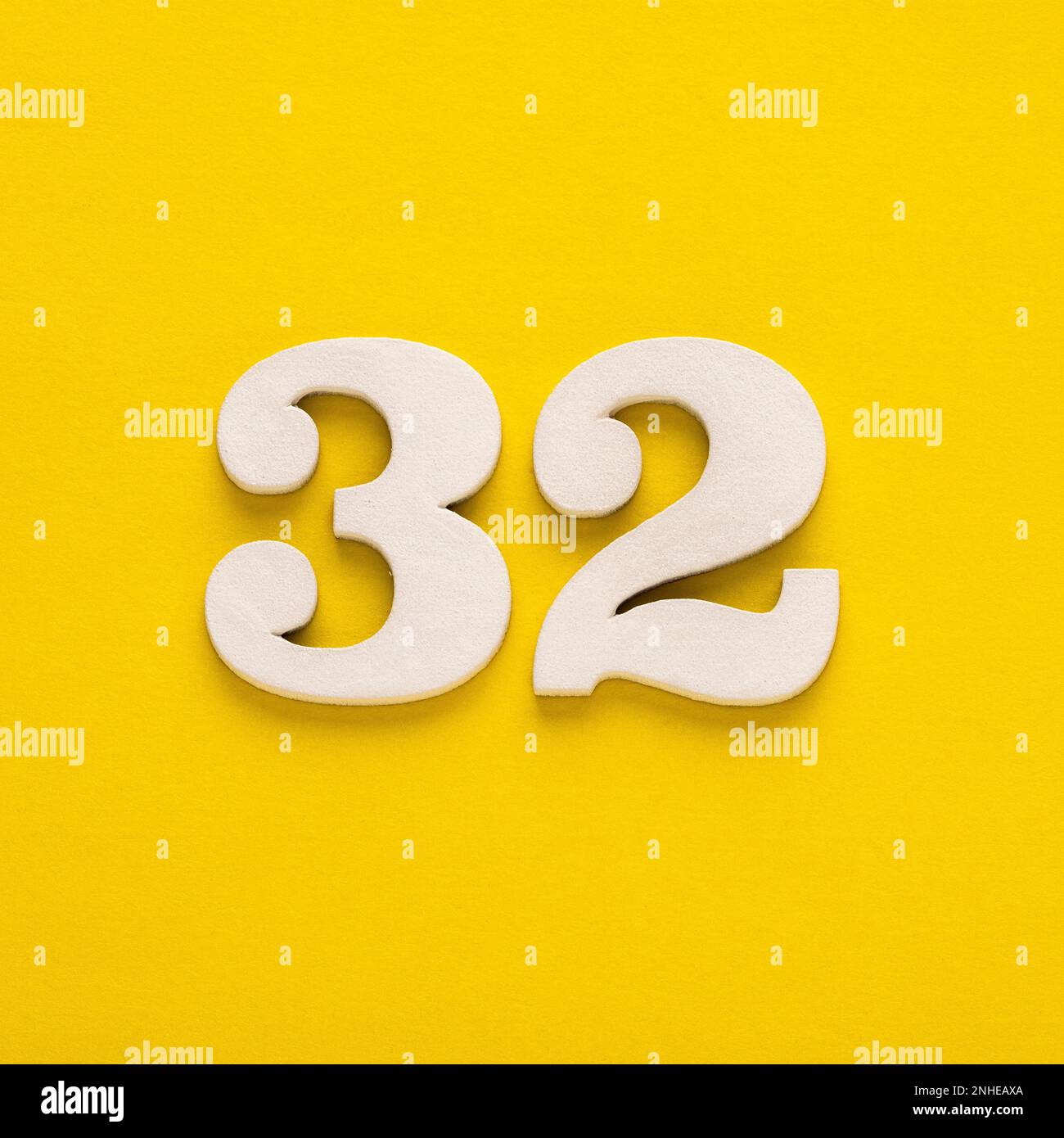 Number 32 on a yellow background - Two-digit number in white Stock ...