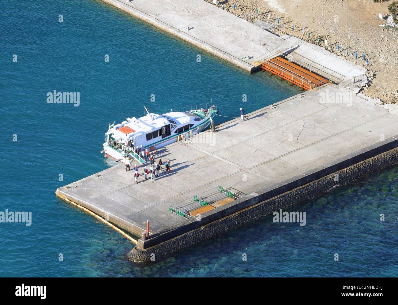 Workers are at Mageshima Island in Iriomote City, Kagoshima Prefecture ...