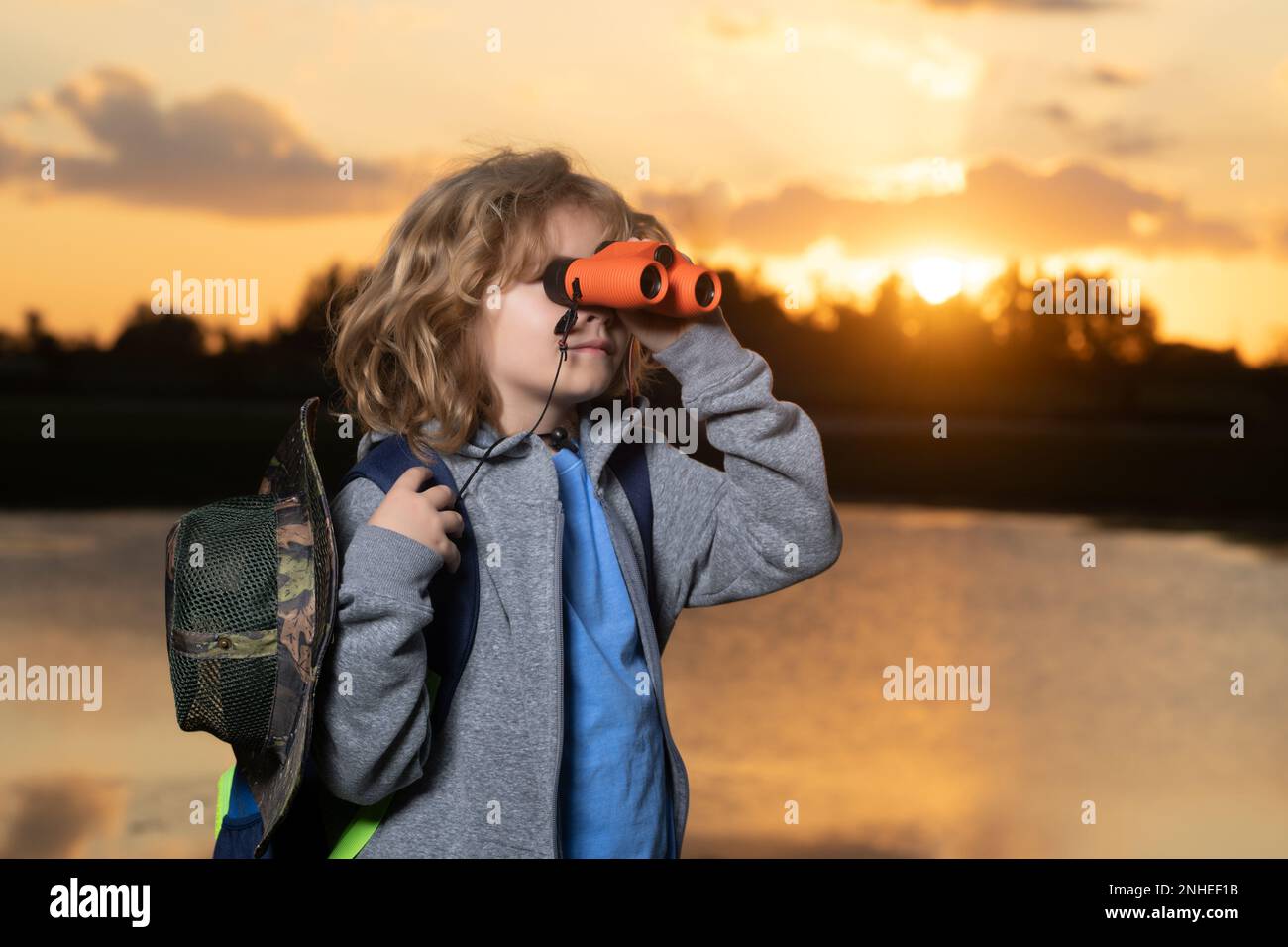 Childhood. Young boy looking through binoculars. Explore and adventure ...