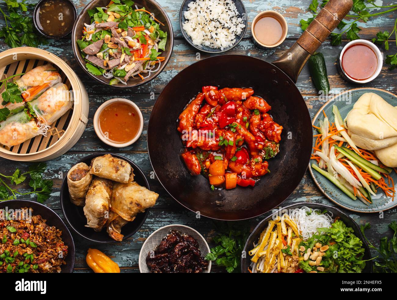 Set of assorted Chinese dishes on table: sweet and sour chicken in wok ...