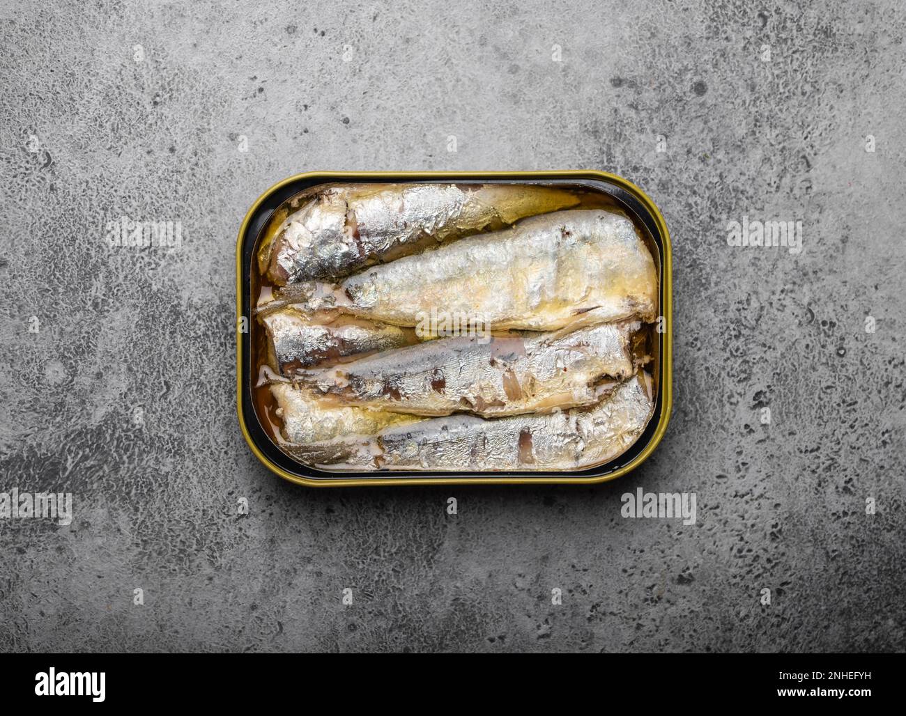 Close up and top view of canned sardine in a tin over gray rustic ...