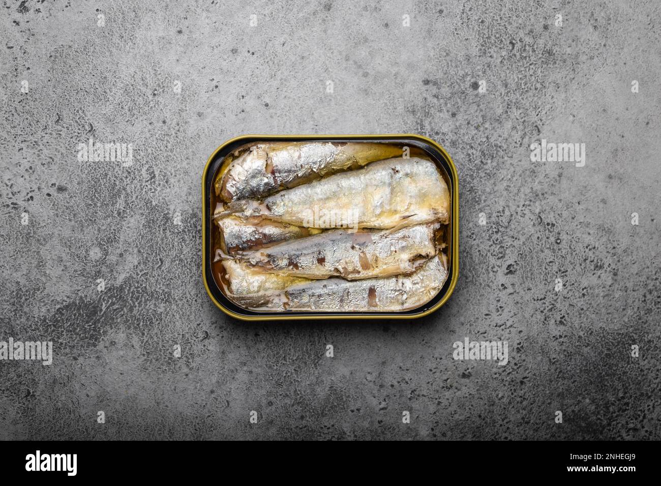 Close up and top view of canned sardine in a tin over gray rustic ...