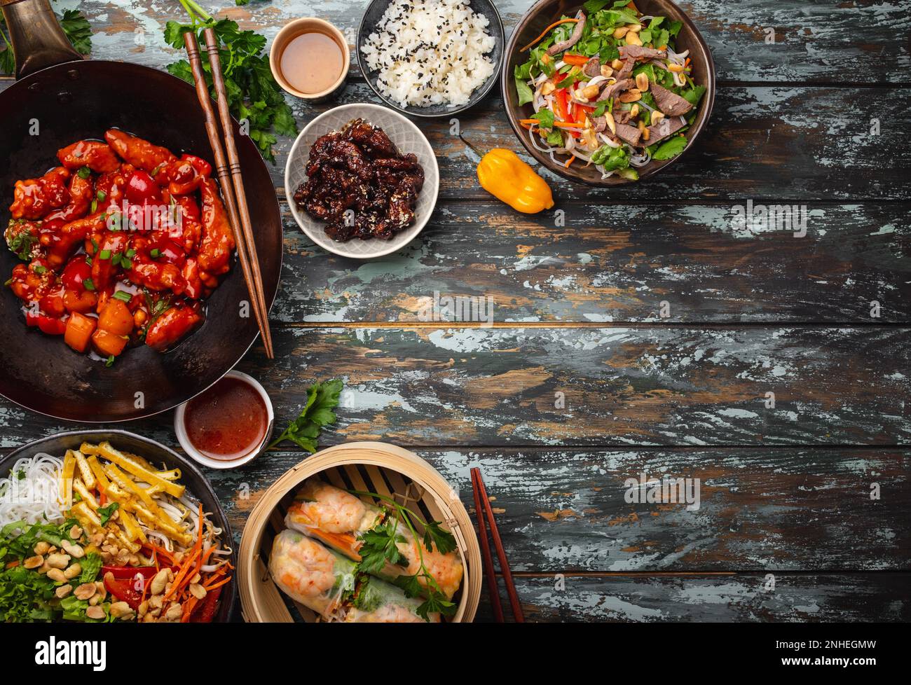 Set of assorted Chinese dishes on table: sweet and sour chicken in wok ...