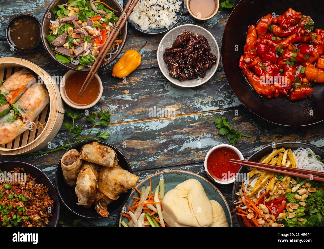 Set of assorted Chinese dishes on table: sweet and sour chicken in wok ...