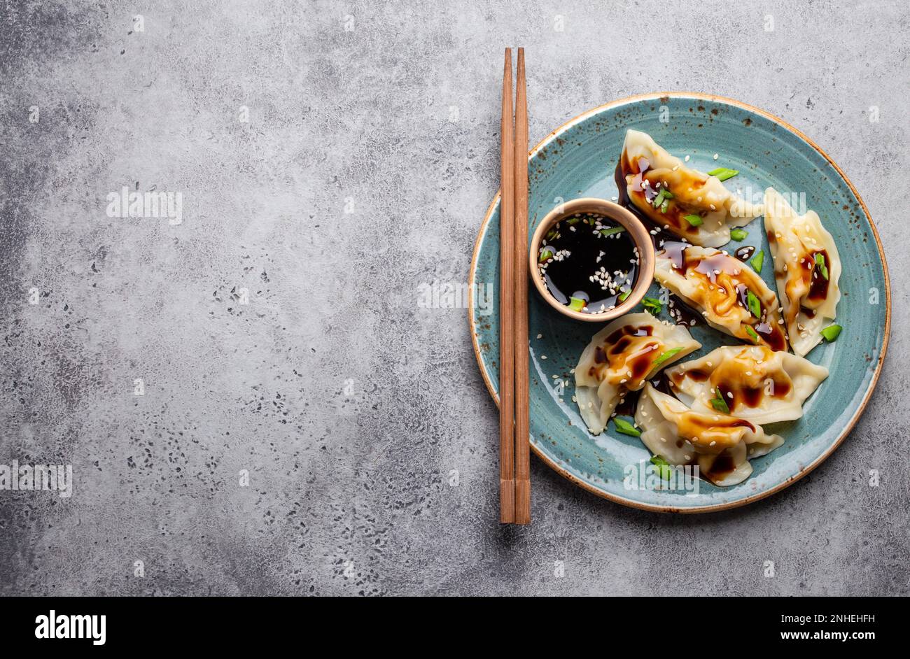 Close-up, top view of traditional Asian dumplings on blue plate with ...