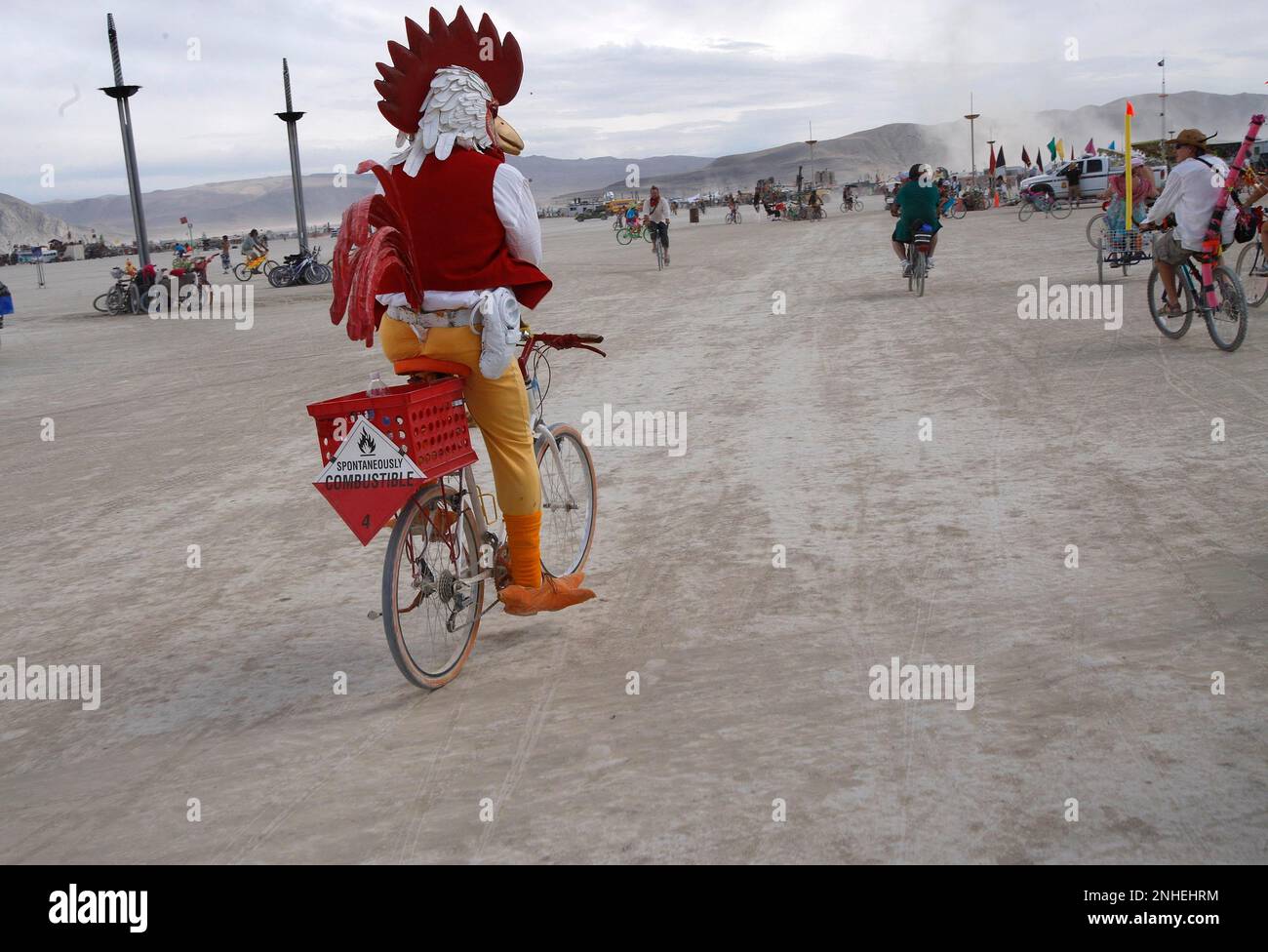 burningman 137 mac.jpg A man in a chicken suit rides along Esplande in ...
