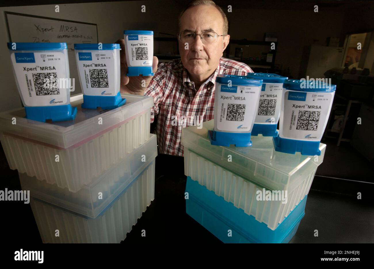 John Bishop, CEO of Cepheid, shows the cartridges where samples are ...