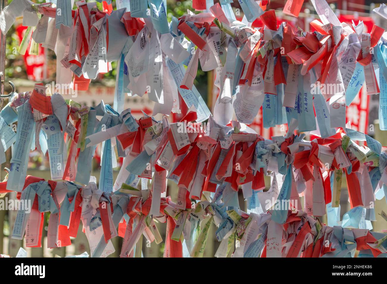 Omikuji, small strips of paper with fortunes or prayers written on them ...