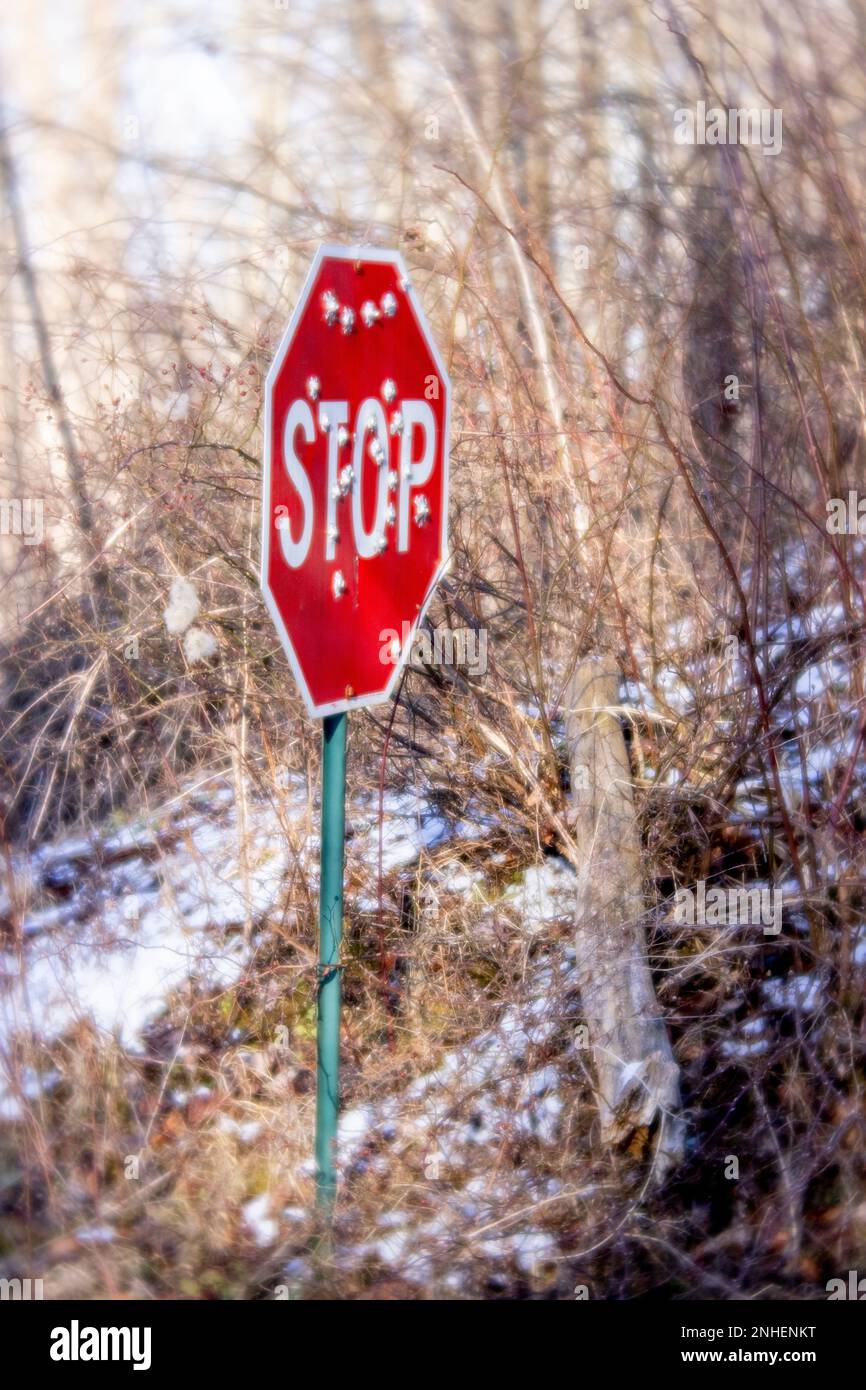 A red stop sign along a back road in Pennsylvania stands straight and ...