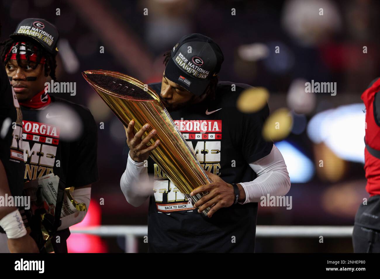 A Georgia Bulldogs player kisses the trophy after winning the CFP ...