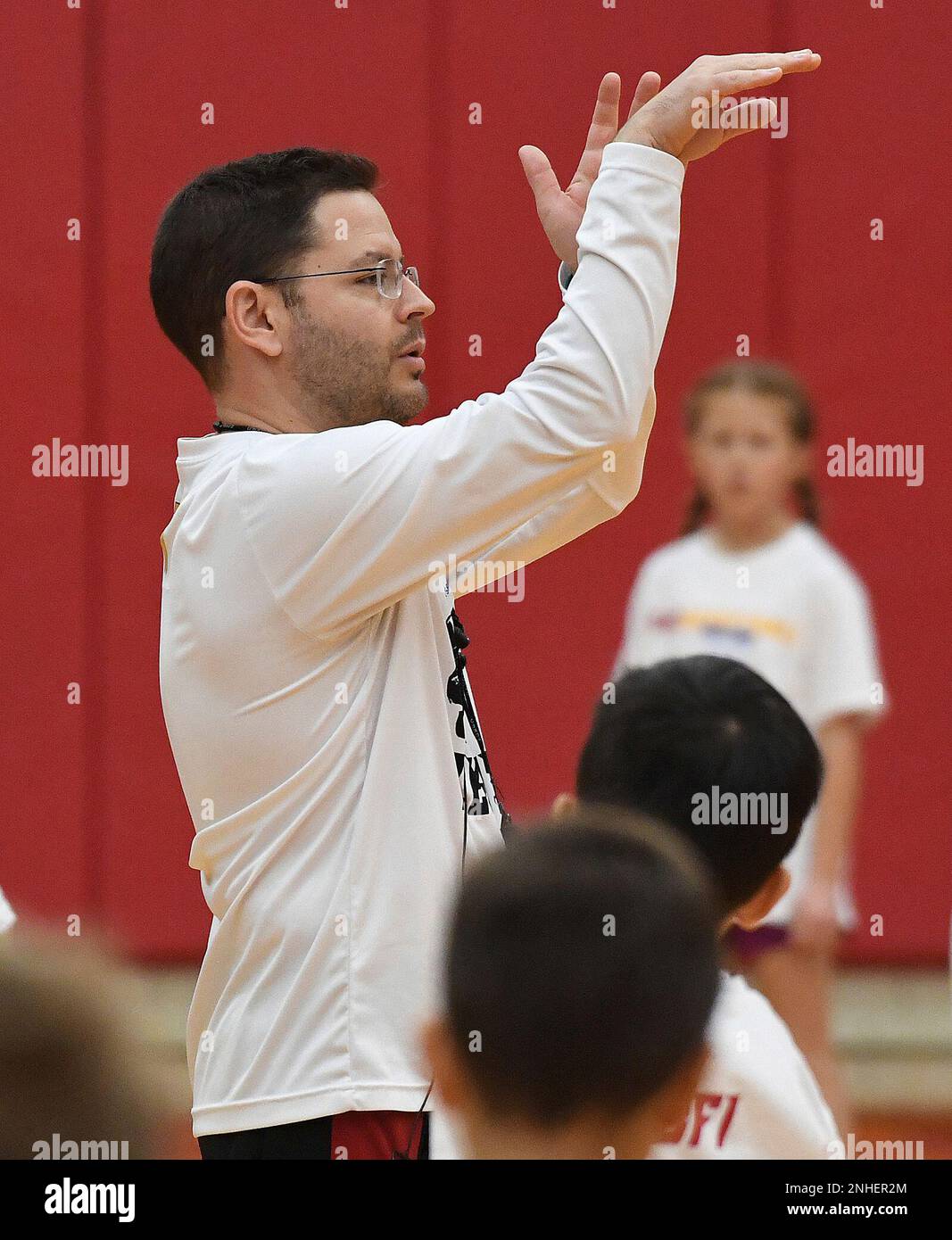 AWC Head Coach Kyle Isaacs demonstrates the correct shooting form for ...