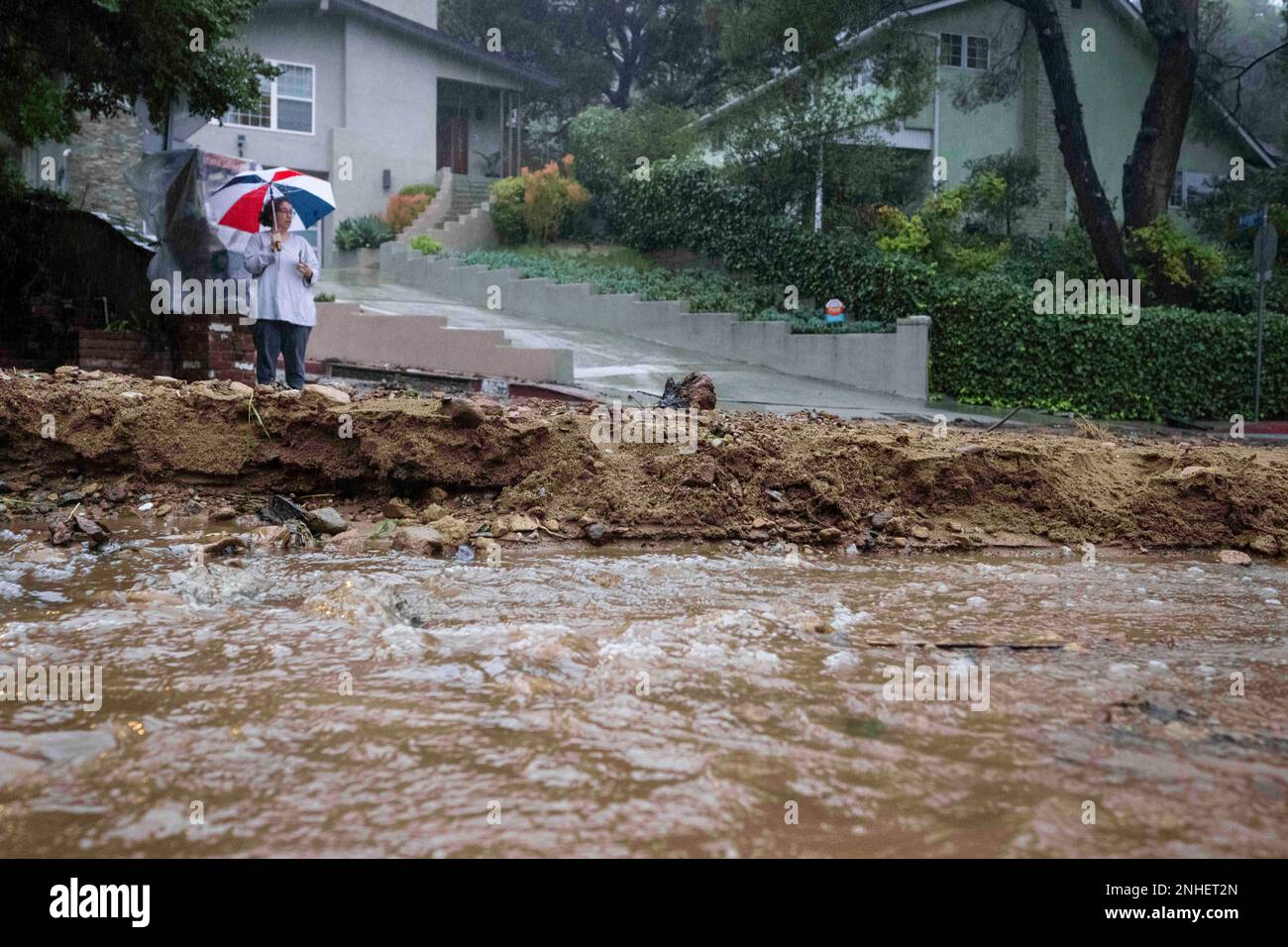 A resident keeps watch on Fredonia Drive in Studio City, Calif., where a mudslide is blocking ...
