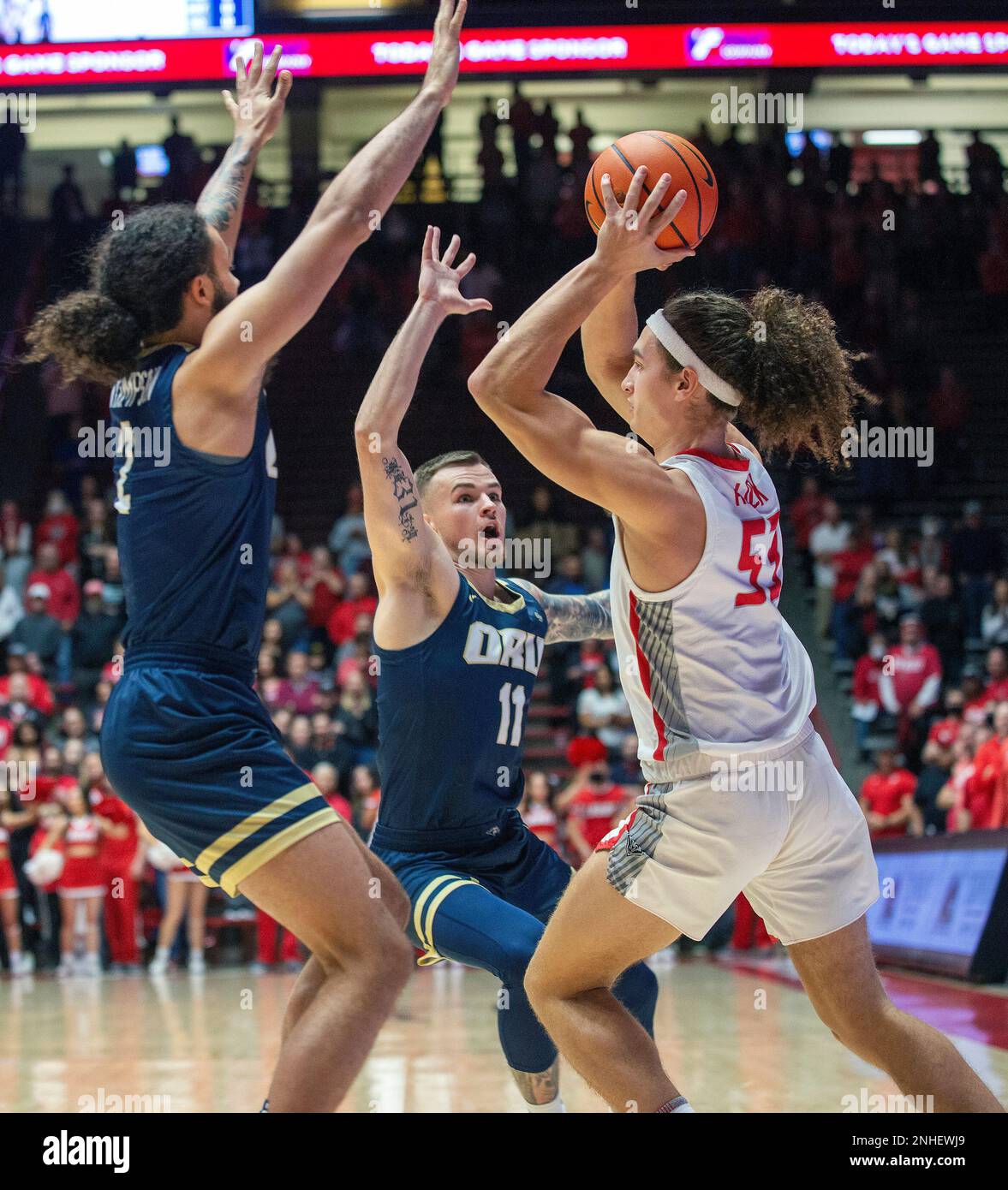 New Mexico forward Josiah Allick, right, is pressured by Oral Roberts ...