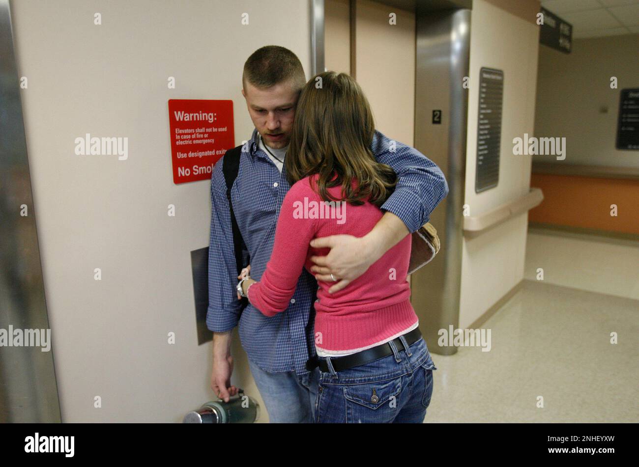 blake3 031 mac.jpg Blake gives his wife a hug as they wait for an ...