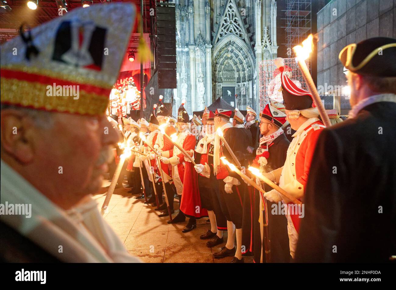 Cologne, Germany. 21st Feb, 2023. Carnivalists hold torches during the ...