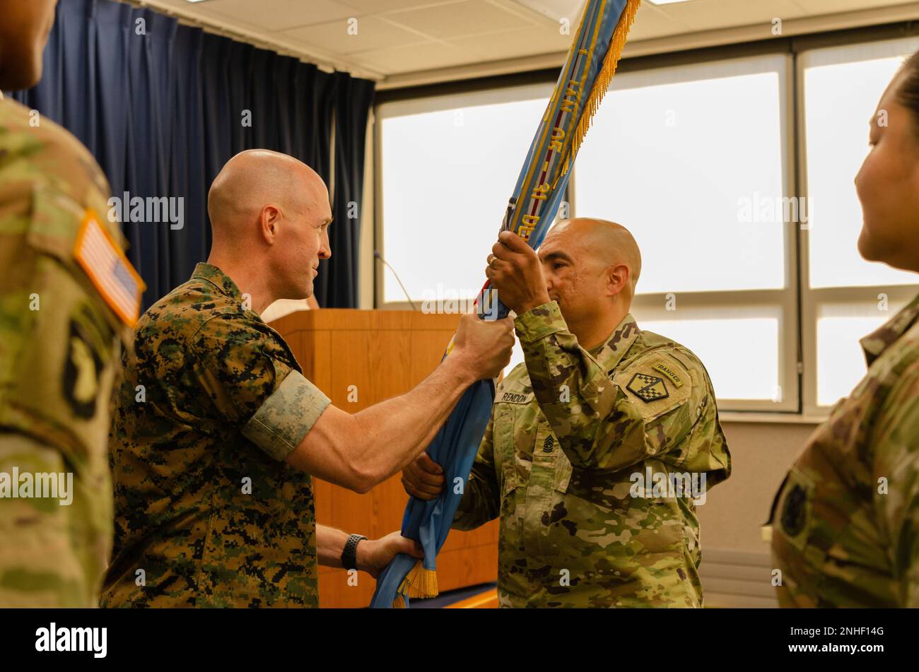 Western Sector Commander, Col. Jesse L. Sjoberg passes the unit guidon ...