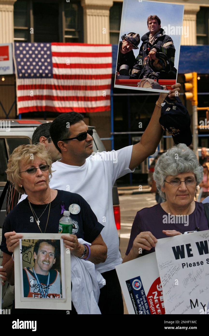 911nyc 09 096 mac.jpg l to r- Rosemarie Reina, holds a photo of her son ...