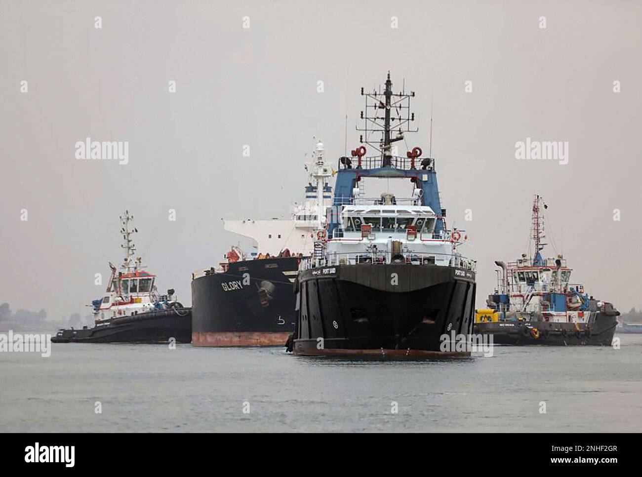 In this photo released by Suez Canal Authority, tugboats pull the ship ...