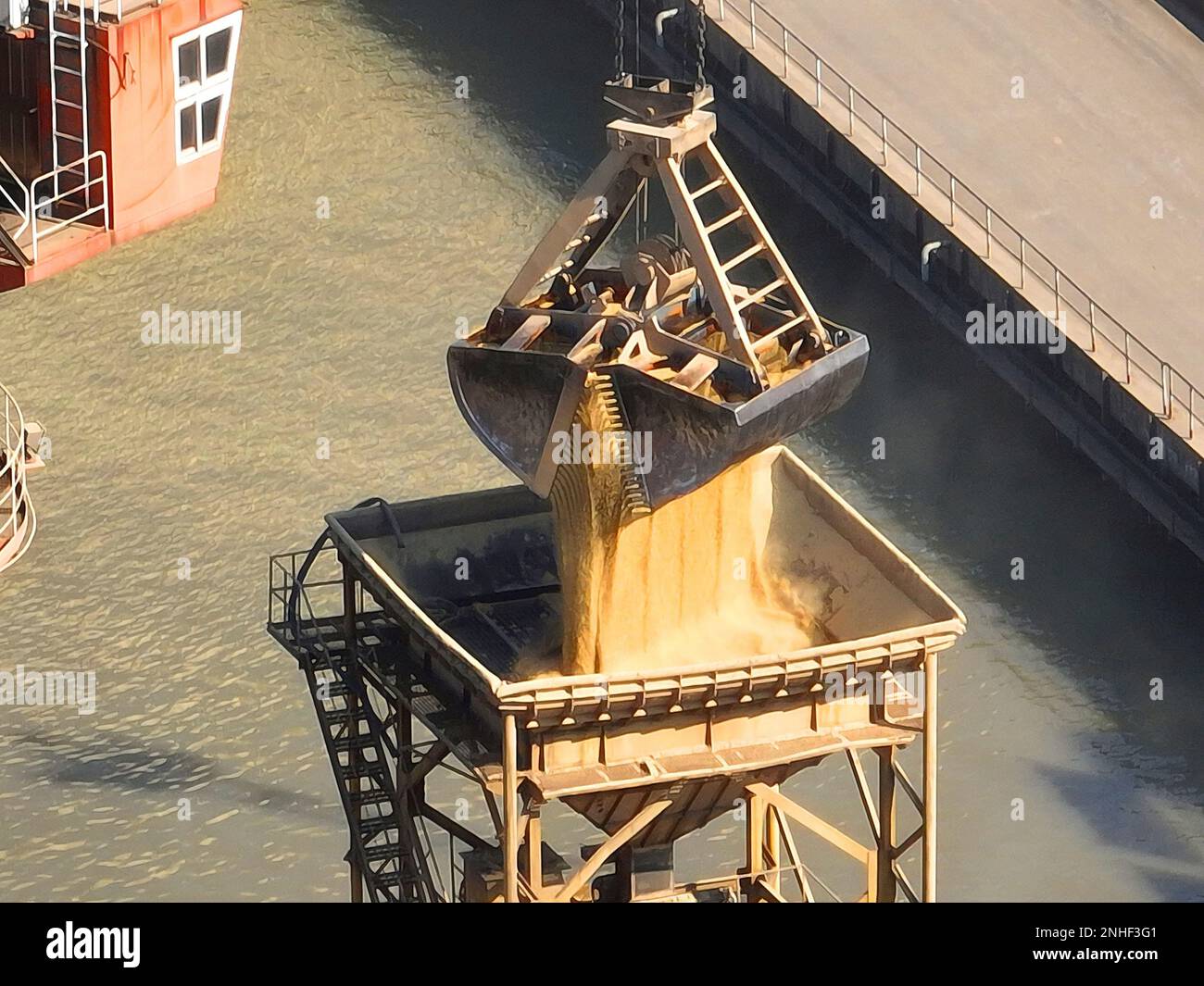 Equipment load barley imported from Canada off a ship at a dockyard in ...