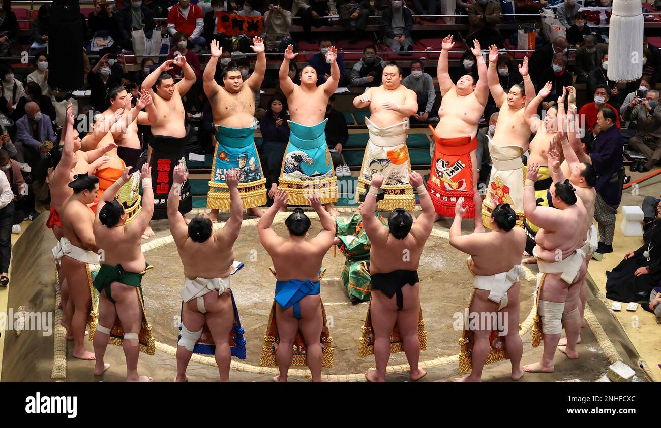 Sumo wrestlers raise their hands during the ceremony of entering the ...