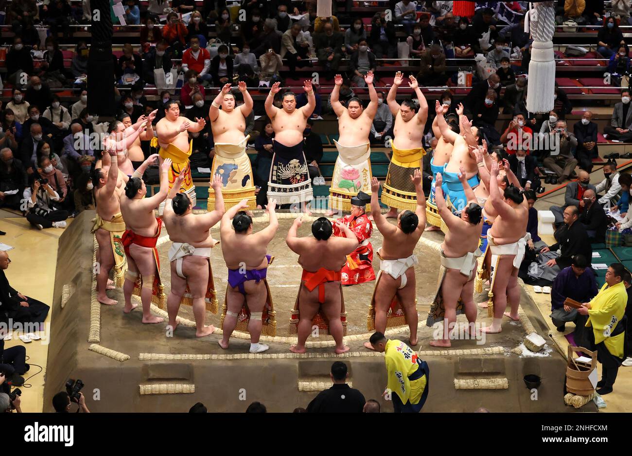 Sumo wrestlers raise their hands during the ceremony of entering the ...