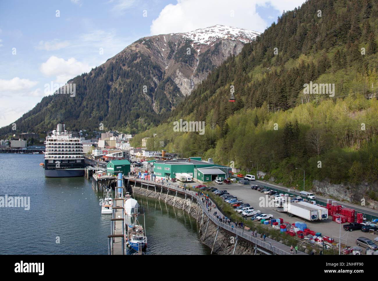 The springtime view of a cruise ship moored in Juneau town port and ...