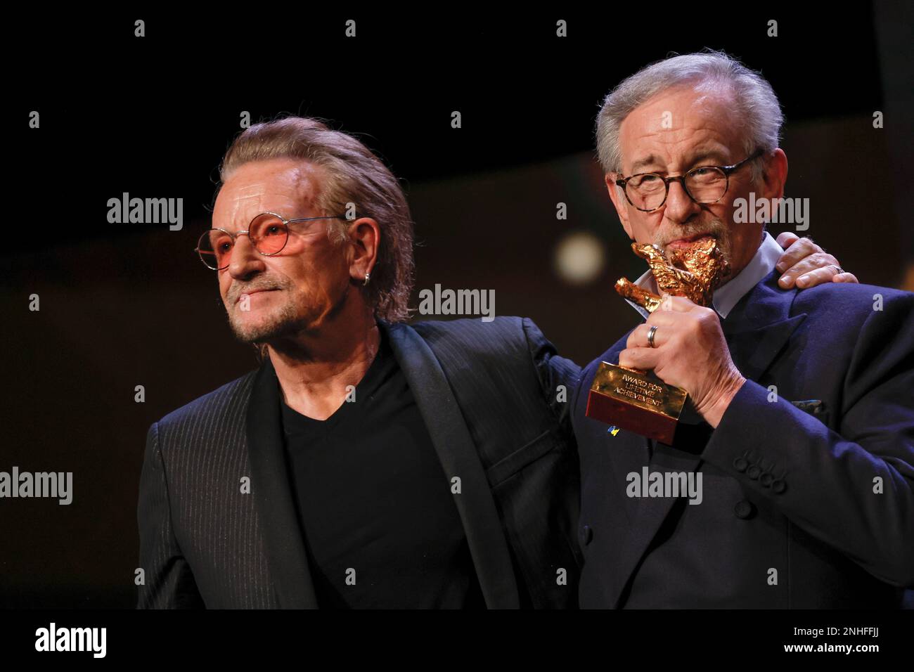 Steven Spielberg holds his honorary Golden Bear presented by Bono, left ...
