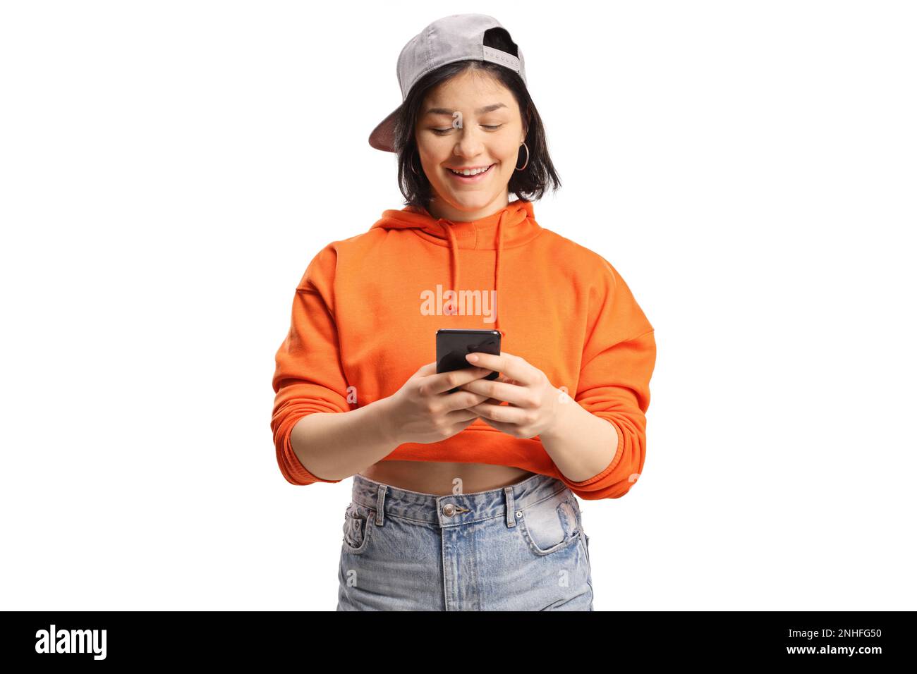 Cheerful gen z female using a smartphone isolated on white background ...