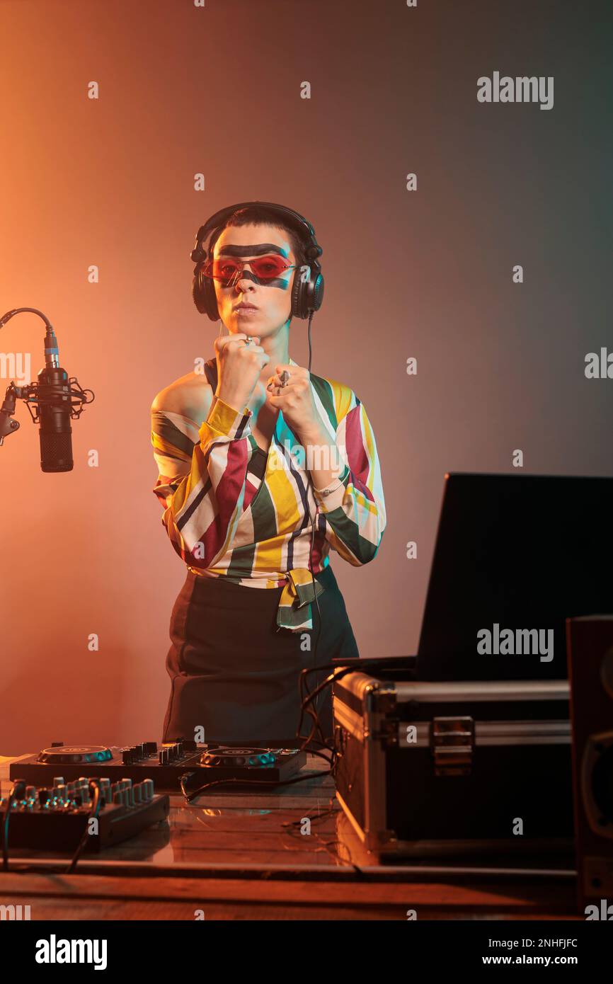 Aggressive DJ having clenched fists in studio, showing fight threat ...