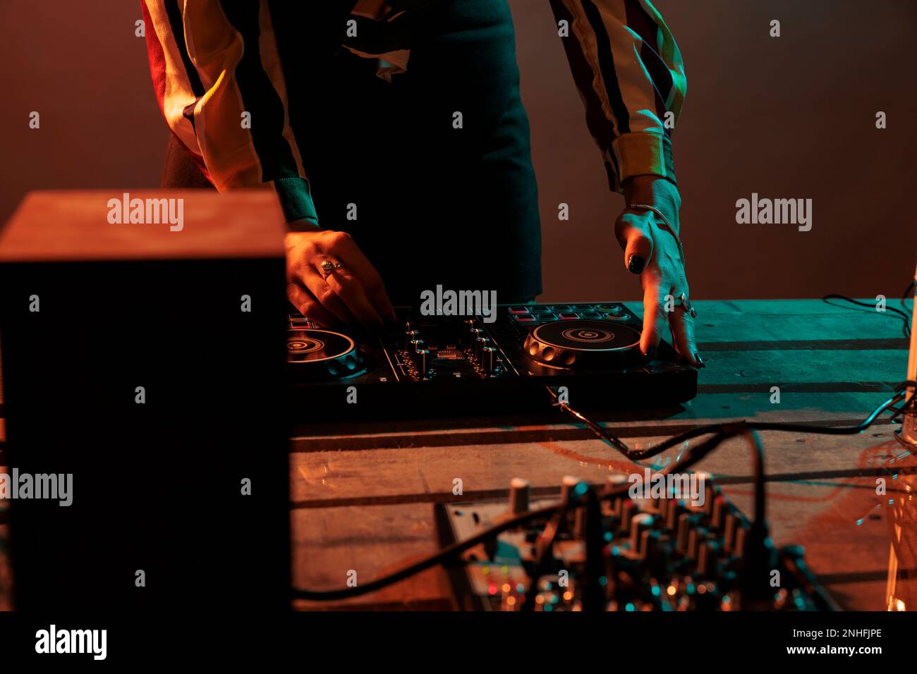 Musical artist mixing techno music on turntables, playing record mix ...