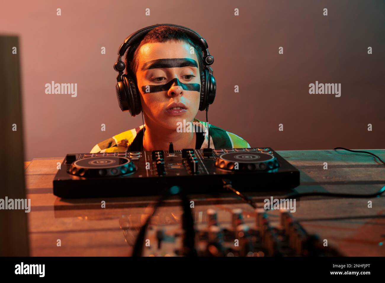 Female artist looking at dj turntables in studio, preparing to mix ...