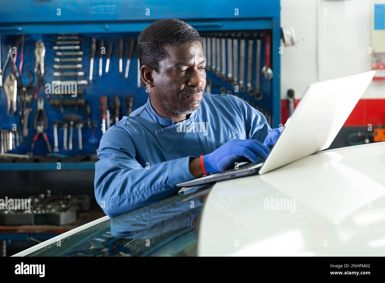Automobile diagnosis. Car mechanic repairer looks for engine failure ...