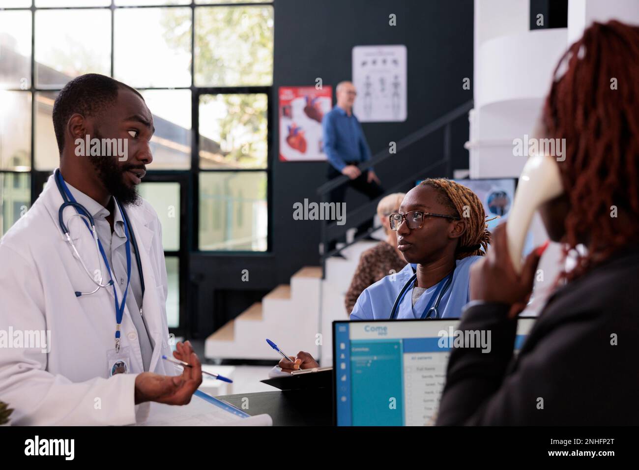 Practitioner doctor talking with medical assistant discussing patient ...