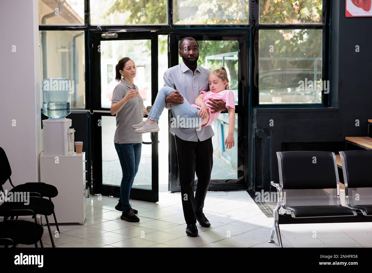 African american father holding unconscious daughter in arms after ...
