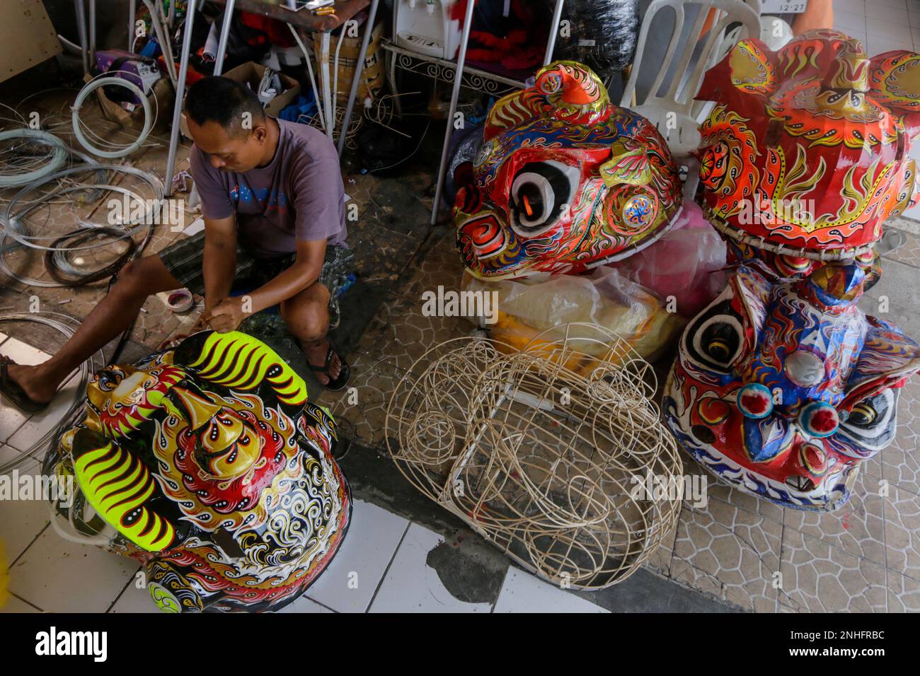 A craftsman produces parts of a lion dance costume ordered by customers ...
