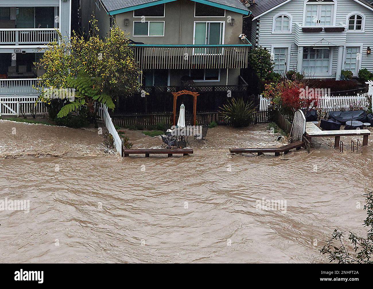 Yards along Soquel Creek in Capitola Village are flooded by a storm ...