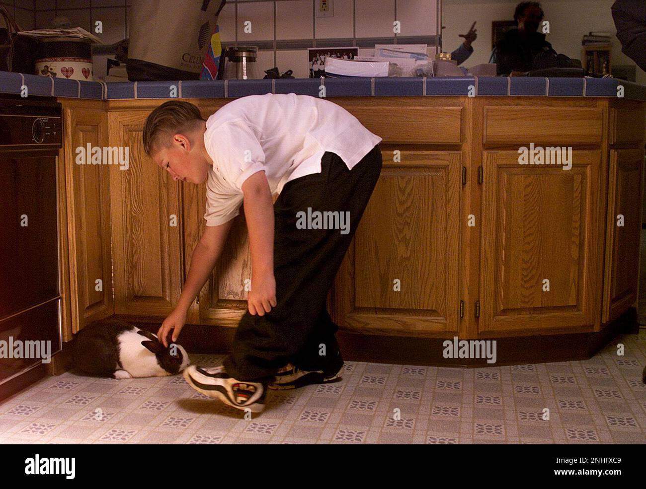 RABBIT2-C-28APR99-MN-MAC Justin Freitas 11, just home from school ...