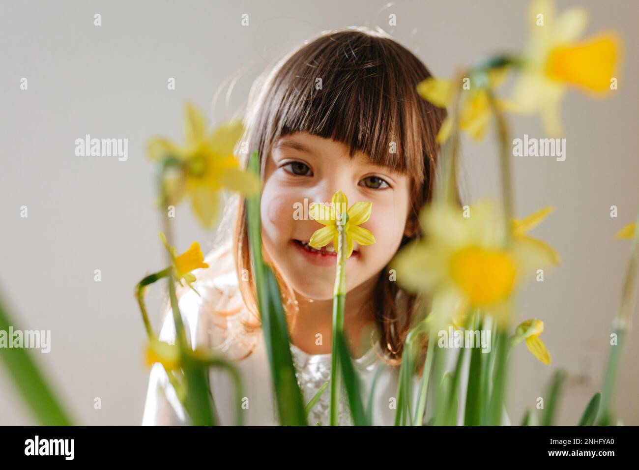 Little girl sniffing flowers hi-res stock photography and images - Alamy