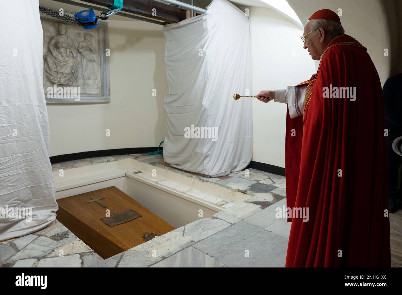 A priest observes the coffin of Pope Emeritus Benedict XVI in the ...