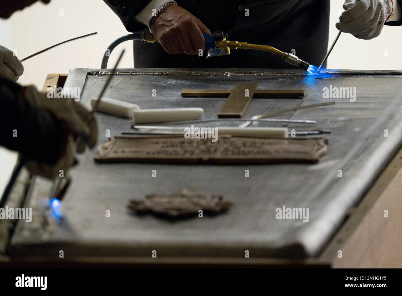 A man welds the coffin of Pope Emeritus Benedict XVI in the Vatican ...