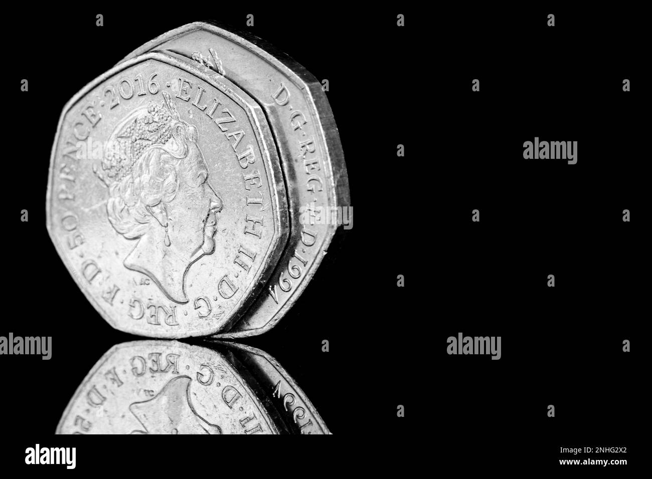 Size comparison between the old large 50p coin & the smaller new 50p ...